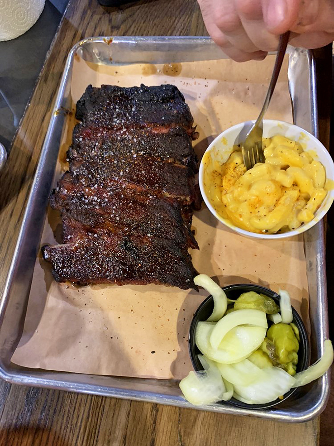 Barbecue ribs with that perfect smoke ring, accompanied by mac and cheese that deserves its own fan club.