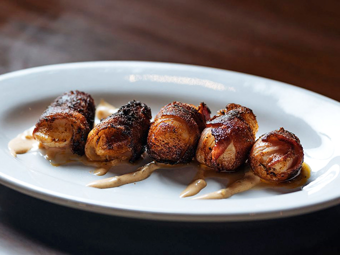 Bacon-wrapped scallops: Because sometimes good things come in small packages. These little flavor bombs are like ocean candy for grown-ups.