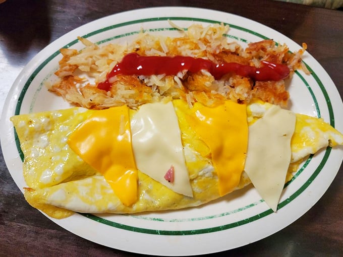 The Big Dagwood Omelet contains more fillings than my first apartment had furniture. A beautiful chaos of bacon, sausage, ham, and veggies under a blanket of cheese.
