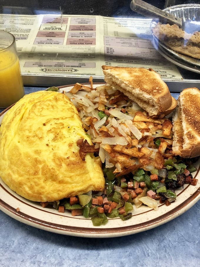 Now that's what I call a balanced breakfast! Eggs, hash browns, bacon, and pancakes join forces to create a meal that could fuel you through a Minnesota winter.