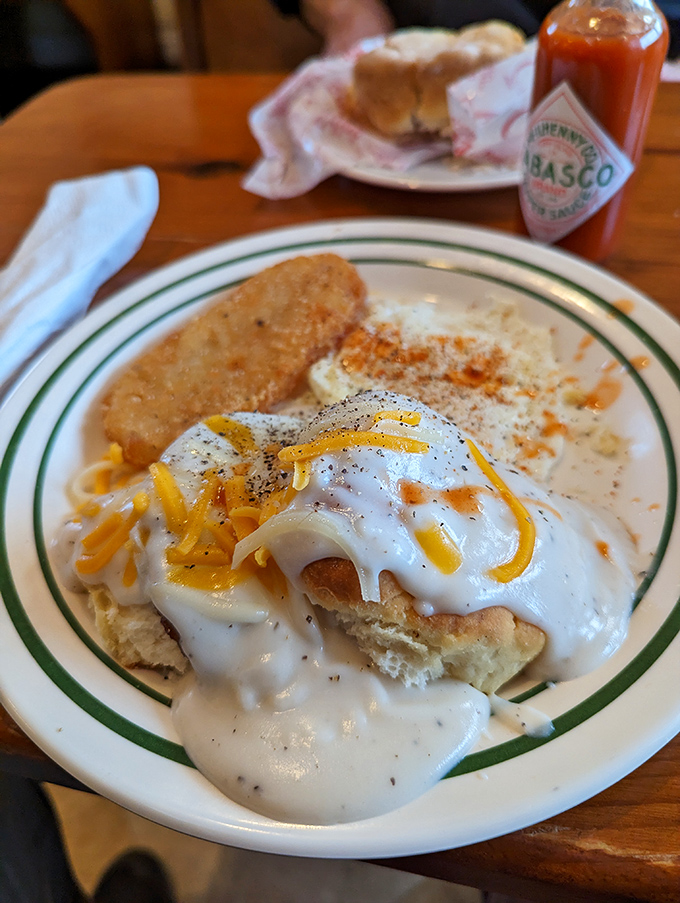 Breakfast perfection on a plate: fluffy biscuits, creamy gravy, and enough cheese to make a mouse swoon. Diets, beware &ndash; resistance is futile!