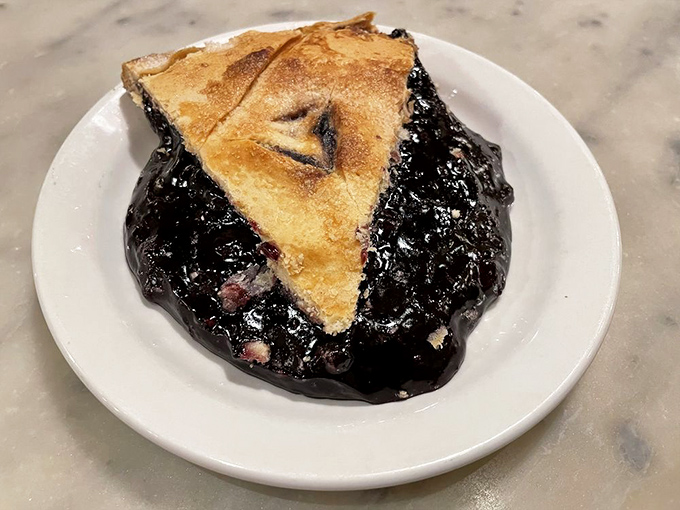 This isn't just pie, it's a slice of heaven on a plate! With a filling so purple it could make Prince jealous, this blueberry beauty is ready for its close-up.