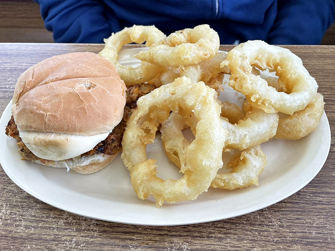 The dynamic duo of diner delights: a burger that means business and onion rings that could double as edible jewelry.
