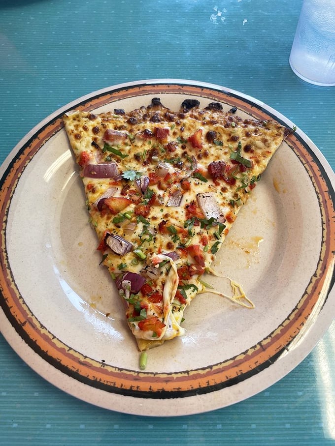One slice to rule them all! This Butter Chicken pizza slice is so good, it might just solve world peace... or at least dinner indecision.