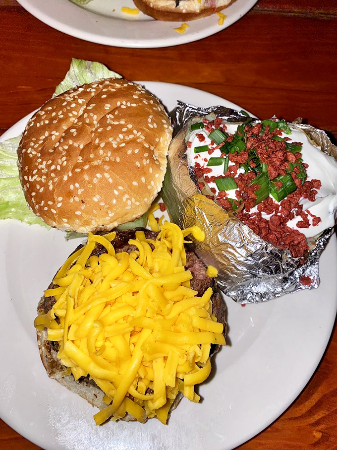 The dynamic duo of comfort food: a burger that could feed a small country and a baked potato playing sidekick.