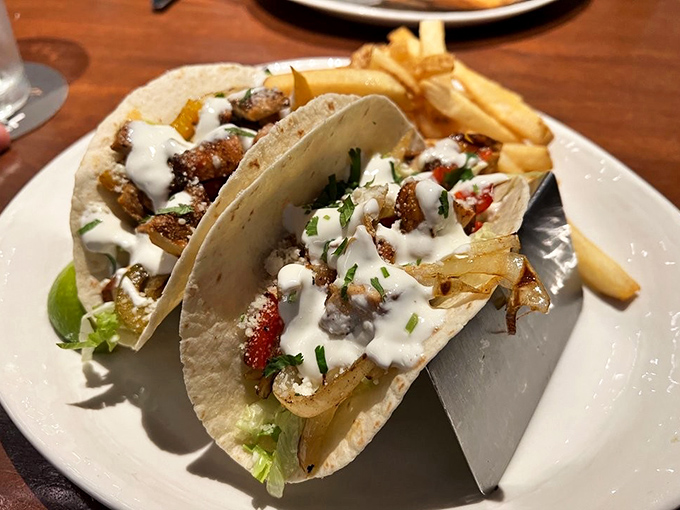 Tacos that require a strategy to eat&mdash;lean in, tilt head, commit fully. The metal holder isn't just practical, it's preventing a delicious escape plan.