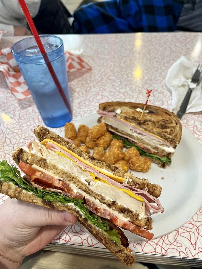 The club sandwich: Where bread, meat, and veggies have a party and you're invited! Stacked higher than a Jenga tower.