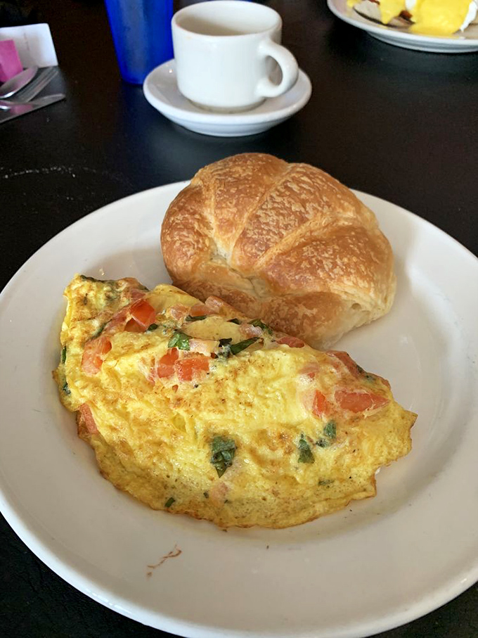 This omelet is fluffier than a cloud over the Seine. Paired with that croissant? It's breakfast nirvana, no passport required.