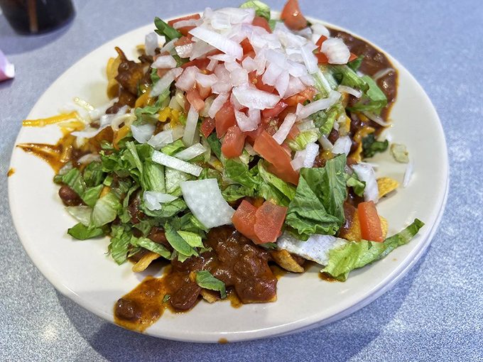 Frito pie: Where comfort food meets Southwest flair. It's like a fiesta in a bowl, topped with enough fresh veggies to make you feel virtuous.