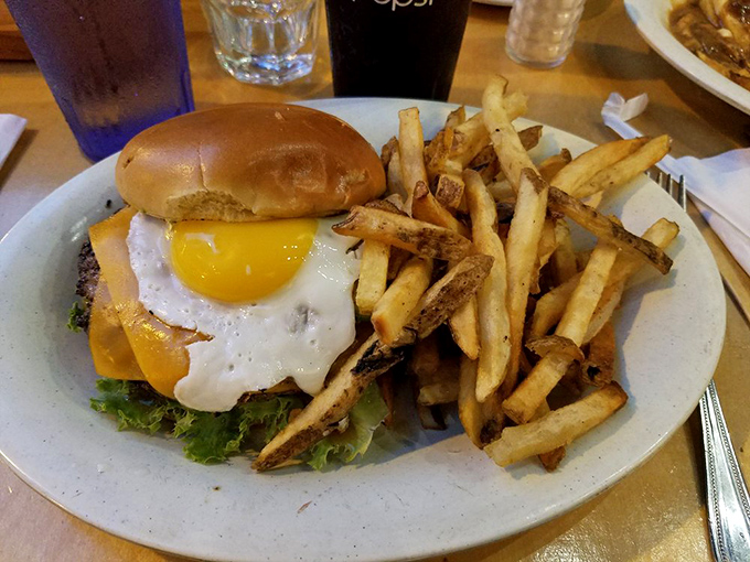 Now that's what we call a great burger! Stacked high with fresh toppings, it's a towering testament to the beauty of simple, well-executed comfort food.