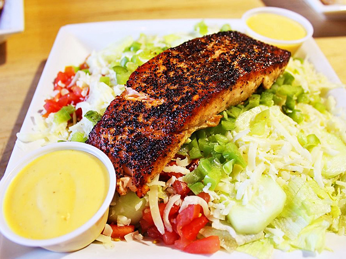 Salmon sensation! This grilled Norwegian beauty atop a bed of greens is like a spa day for your taste buds &ndash; refreshing and indulgent.