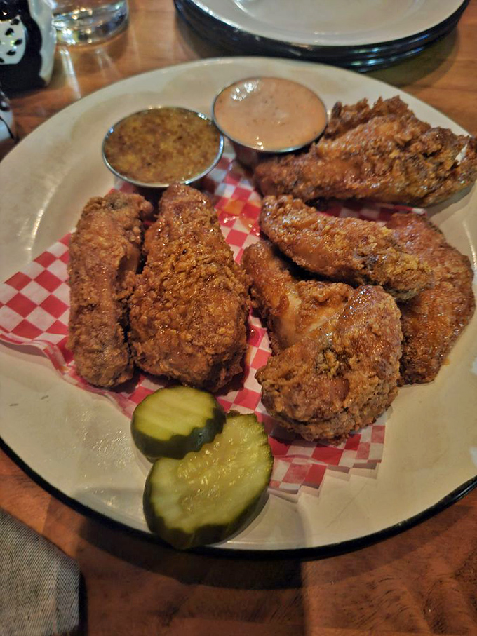 Wings that demand to be photographed before being devoured. The pickle slice isn't just garnish&mdash;it's the acid counterpoint to all that glorious richness.