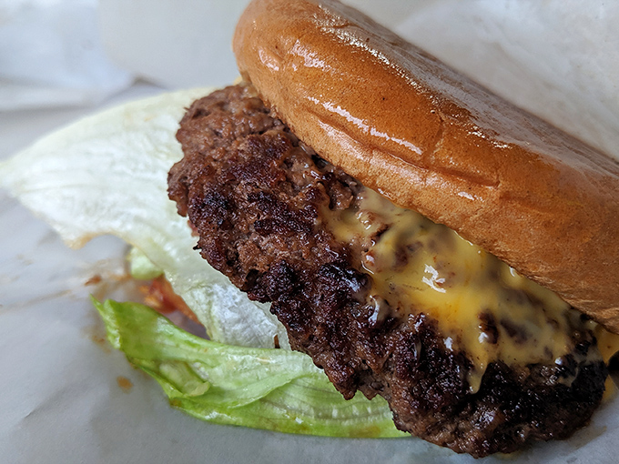 Warning: This burger may cause involuntary drooling. Packed with flavor and oozing cheesy goodness, it's a taste explosion waiting to happen.