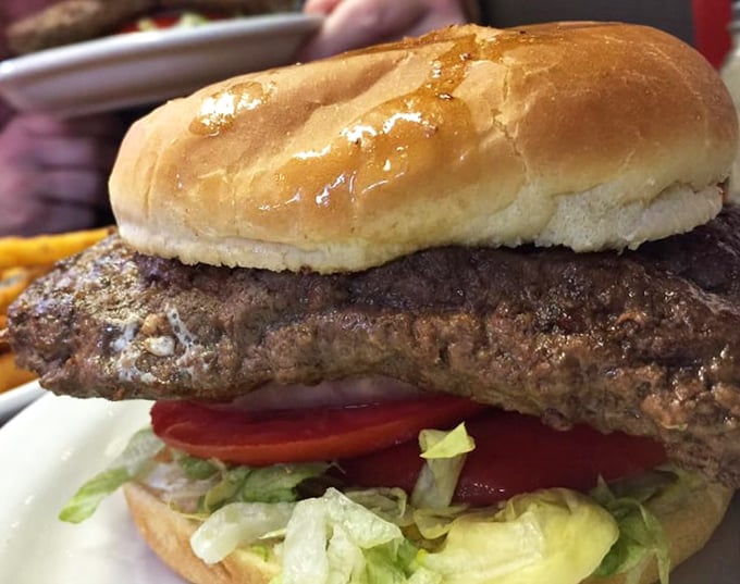 Now that's what I call a burger! This towering masterpiece is so tall, it might need its own zip code.