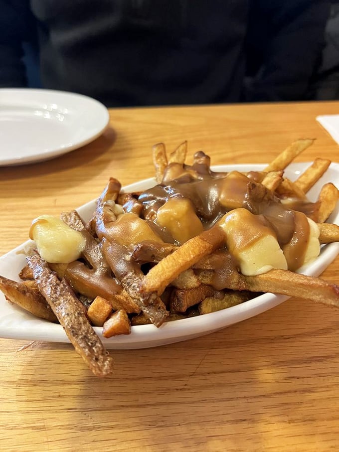 Poutine: where fries, gravy, and cheese curds come together in a holy trinity of comfort food. It's like a warm hug for your taste buds.