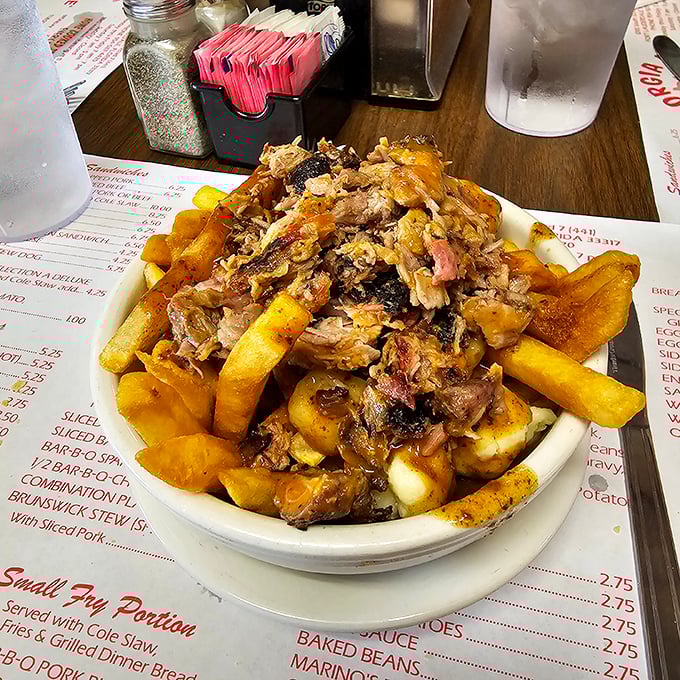 Poutine goes South! This mountain of pulled pork, fries, and gravy is like a delicious game of Jenga for your fork.
