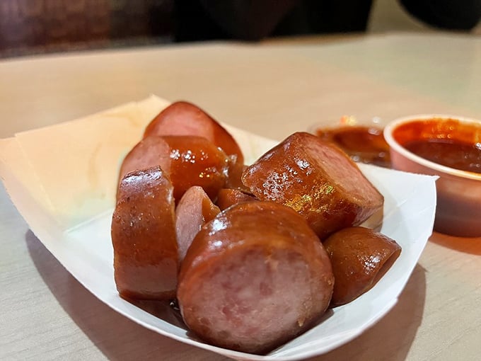 Sausage bites with that perfect snap &ndash; the kind of appetizer that makes you question why you bothered ordering a main course.