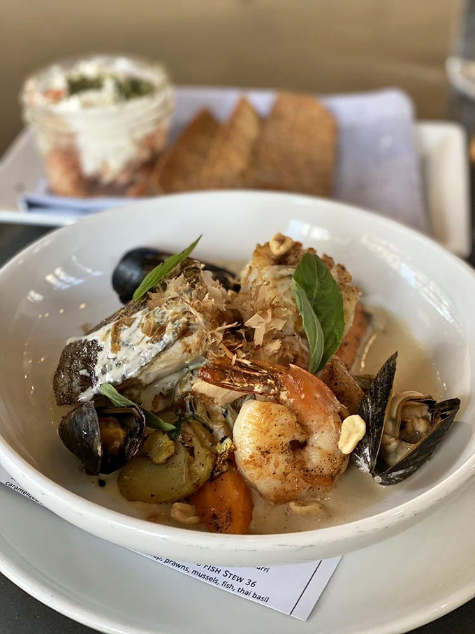 This Thai fish stew is like a warm hug for your taste buds. It's got more layers than a season of Game of Thrones, but way more satisfying.