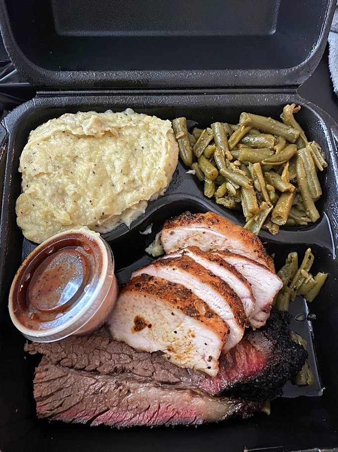 The dynamic duo of barbecue bliss: Juicy chicken and tender brisket join forces with classic sides for a plate of pure comfort.