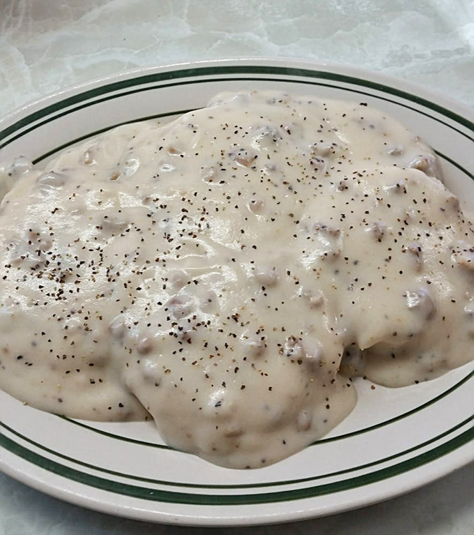 Comfort food alert! This plate of biscuits and gravy is like a warm hug for your taste buds.