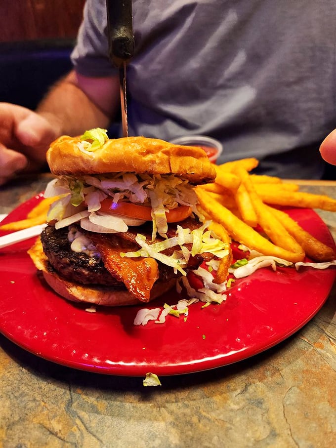 Hold onto your hats, folks! This burger is stacked higher than a Jenga tower and looks just as thrilling to tackle.