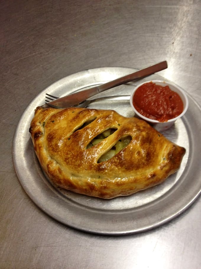 The calzone: Pizza's mysterious, pocket-sized cousin. This golden-brown beauty is like a warm, cheesy hug for your taste buds.