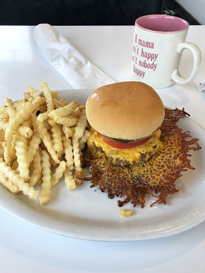 Behold, the cheeseburger in its natural habitat! Surrounded by curly fries, it's a meal that screams "cheat day" in the most delicious way possible.