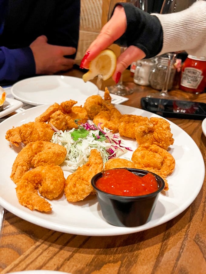 Golden-fried shrimp that look crunchier than a captain's log. Paired with crisp slaw and zesty cocktail sauce, it's a plate of pure coastal joy.