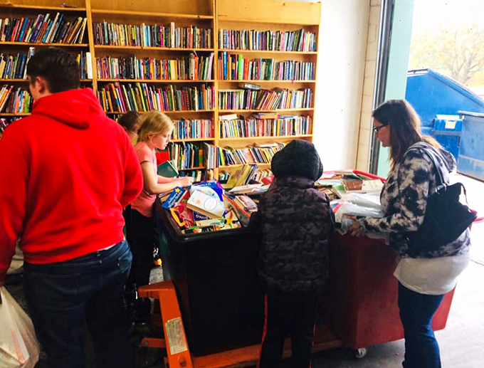 Treasure hunters at work! These folks know the joy of sifting through bins of books - it's like panning for literary gold.