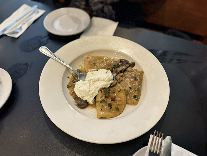 Pillowy pierogies topped with a dollop of sour cream &ndash; Eastern European comfort in bite-sized packages of pure joy.