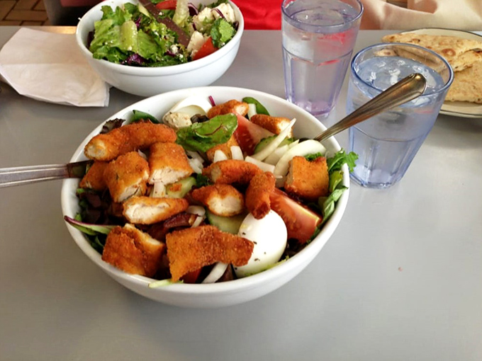 Who says you can't make friends with salad? This colorful bowl is a fresh fiesta, topped with crispy chicken that's clearly been working out.
