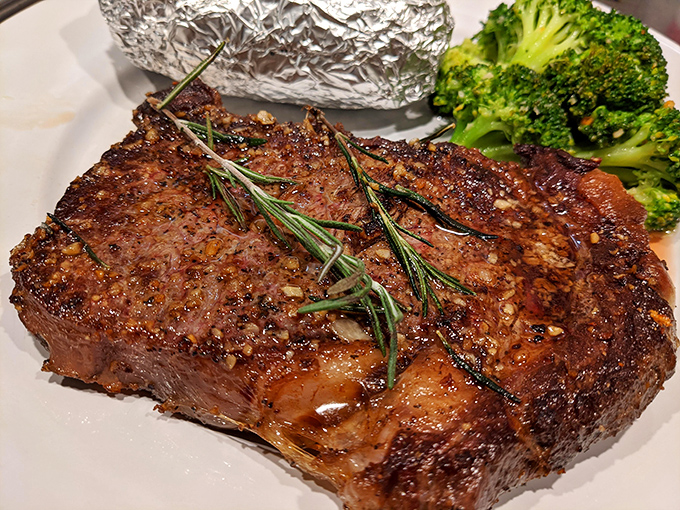 A steak that doesn't need a filter or fancy lighting&mdash;just your undivided attention. The rosemary sprigs aren't just garnish; they're aromatic messengers of what's to come.