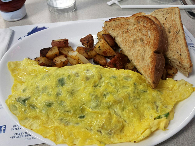 Now that's what I call a three-egg salute! This omelet is so generously stuffed, it's like the filling is trying to make a break for it. Talk about egg-cellent!