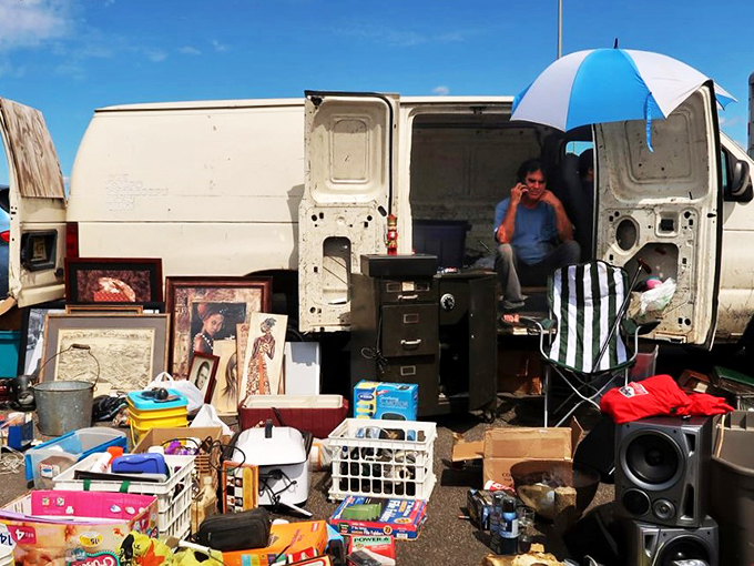 One person's clutter is another's collection! This vendor's van looks like it swallowed a yard sale and is now sharing the wealth with eager shoppers.