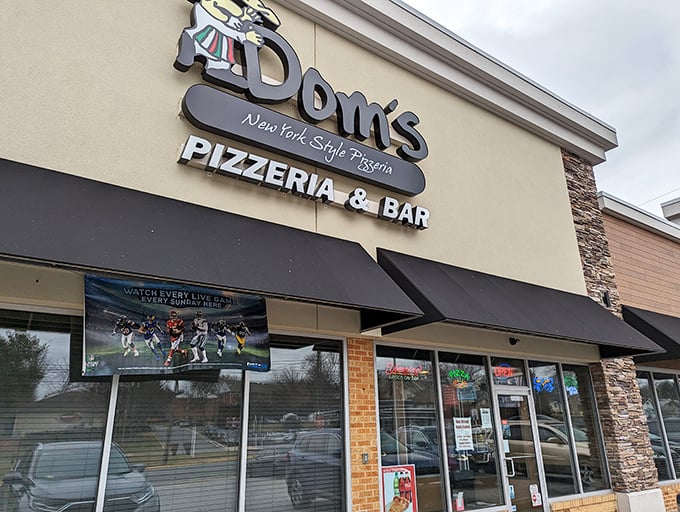 Dom's bold signage makes a New York-sized promise that the massive, foldable slices inside absolutely deliver on.