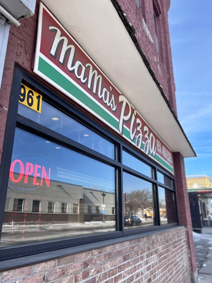 Mama's Pizza sign: Bold letters promise Italian-American comfort. It's like a warm hug from your favorite aunt, if your aunt was made of cheese.