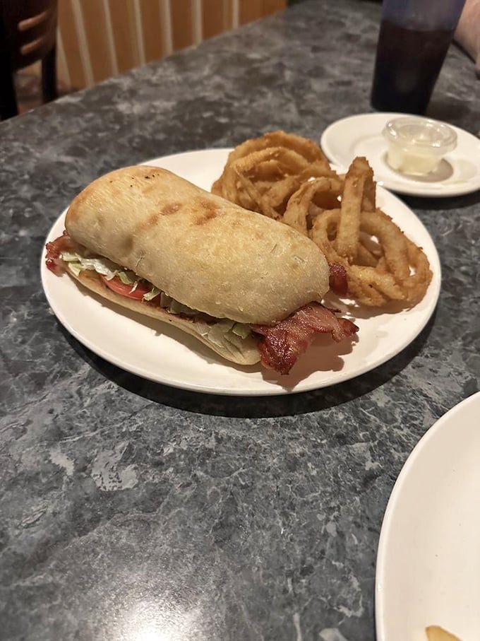 The BLT that'll make you LOL with joy! Crispy bacon, fresh veggies, and a side of golden onion rings? Yes, please!