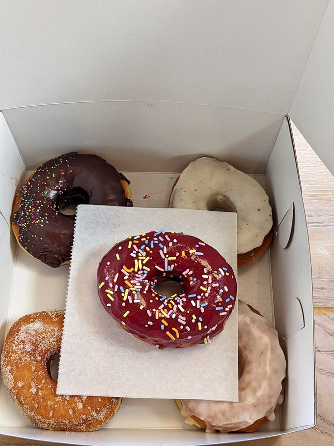 A half-dozen rainbow of possibilities. The green-glazed beauties aren't just donuts—they're edible optimism with sprinkle accessories.