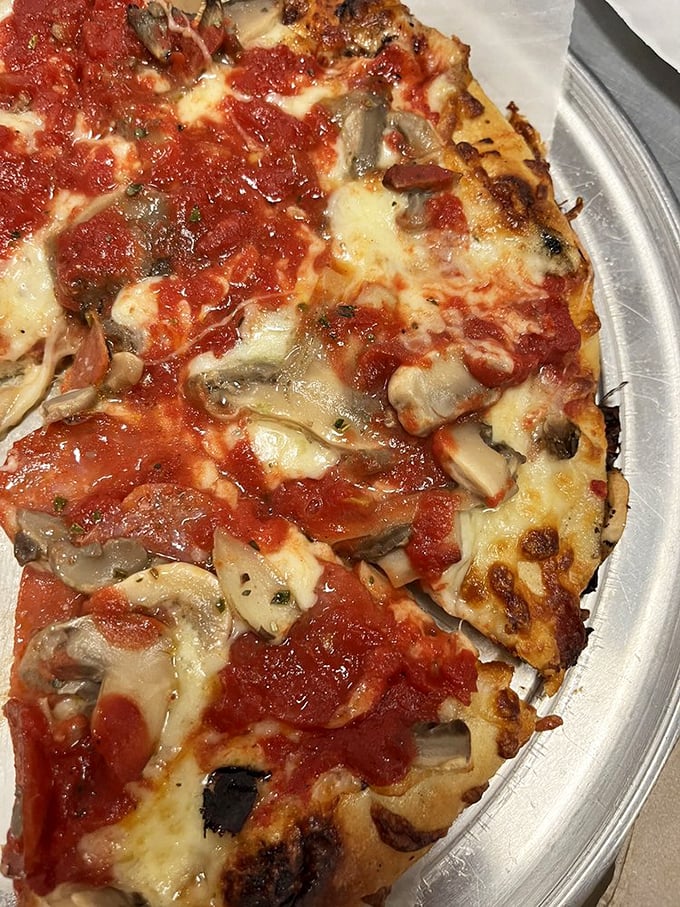 Is this the best pizza in town? One bite of this cheesy, saucy marvel, and you'll swear you've found the Holy Grail of Italian-American cuisine.