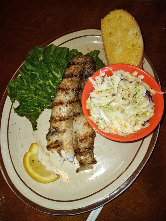 Grilled grouper that's dressed to impress. With a side of slaw and Texas toast, it's a plate that screams "coastal vacation" in the heart of Kentucky.