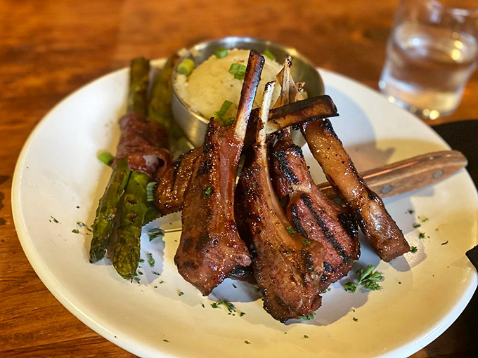 This bone-in lamb chop has been kissed by fire and blessed by sauce.