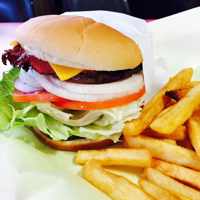 A burger that's gone undercover! This pastrami-topped beauty is like a delicious spy movie for your mouth.