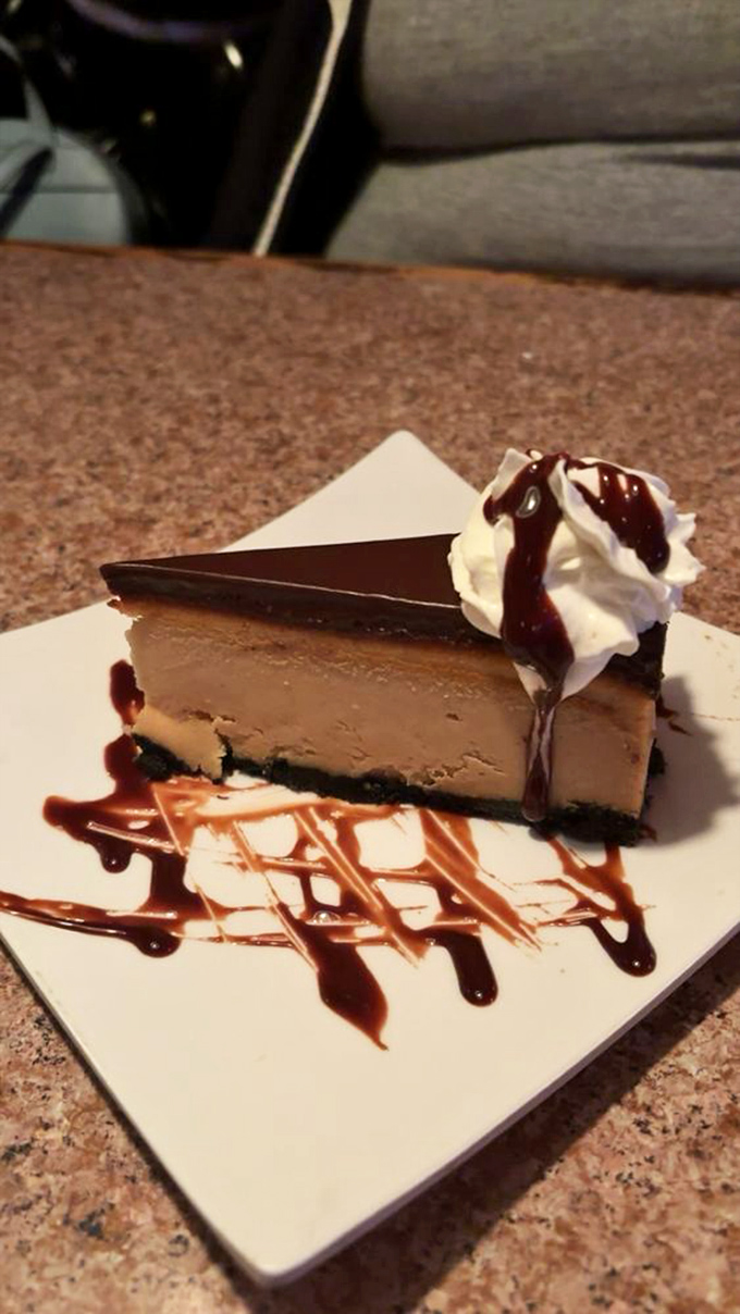 Cheesecake so decadent it should come with a warning label. That chocolate drizzle isn't decoration&mdash;it's the exclamation point on a sweet statement.