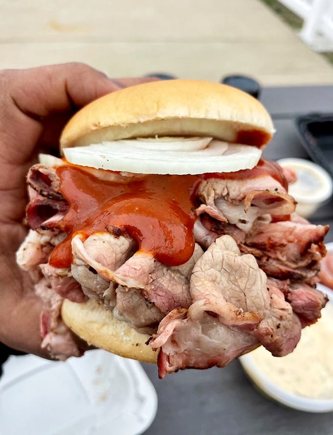 Behold the pit beef behemoth! This sandwich is stacked higher than a Jenga tower, and twice as satisfying when it topples.