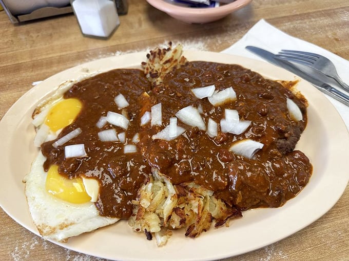 Behold, the legendary Slinger! This hearty heap of hash browns, eggs, and chili is the ultimate hangover cure or pre-hibernation meal.