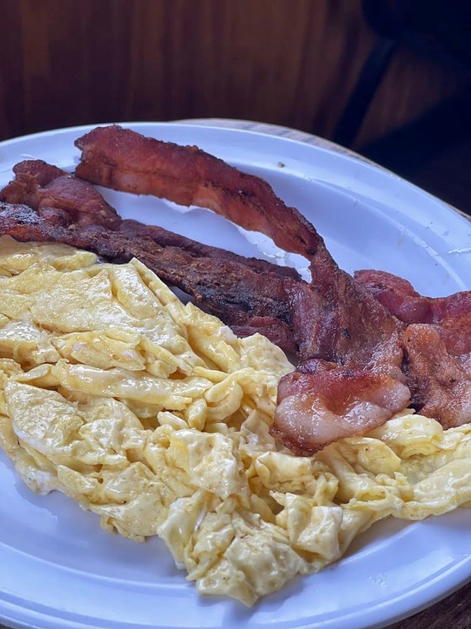 Scrambled eggs so fluffy they practically hover above the plate, with bacon cooked to that perfect point between chewy and crisp. Breakfast fundamentals executed flawlessly.