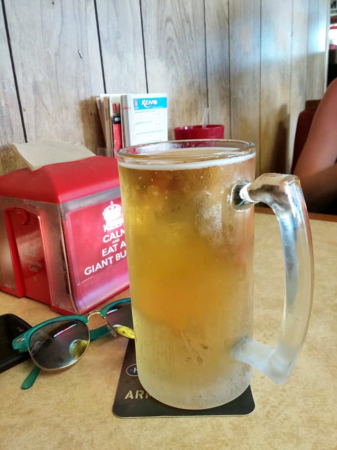 Nothing says "relax and enjoy" quite like an ice-cold brew! This frosty mug is like a little oasis in the middle of burger paradise.
