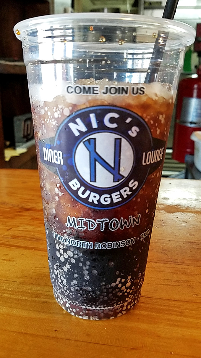 Quench your thirst in style. Nic's branded cup isn't just a vessel; it's a badge of honor for burger aficionados.