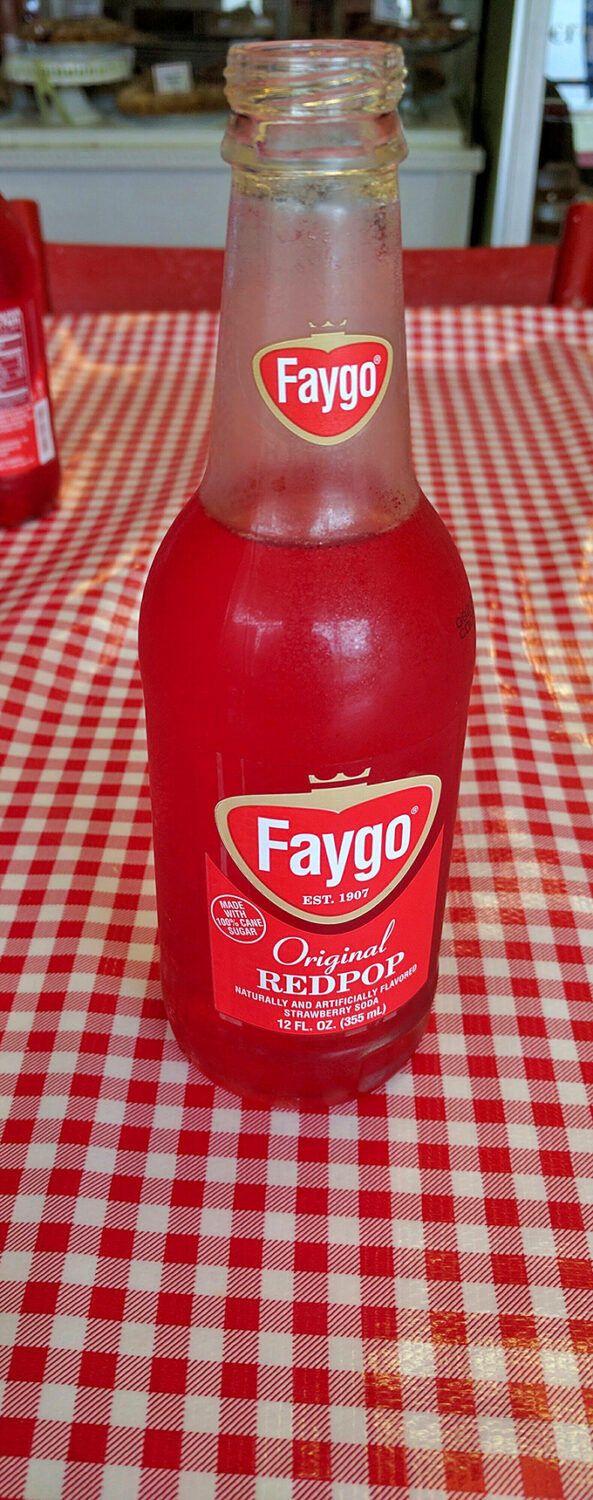 Pop goes the nostalgia! Nothing says "Michigan" quite like an ice-cold Faygo on a checkered tablecloth. It's like summer in a bottle.