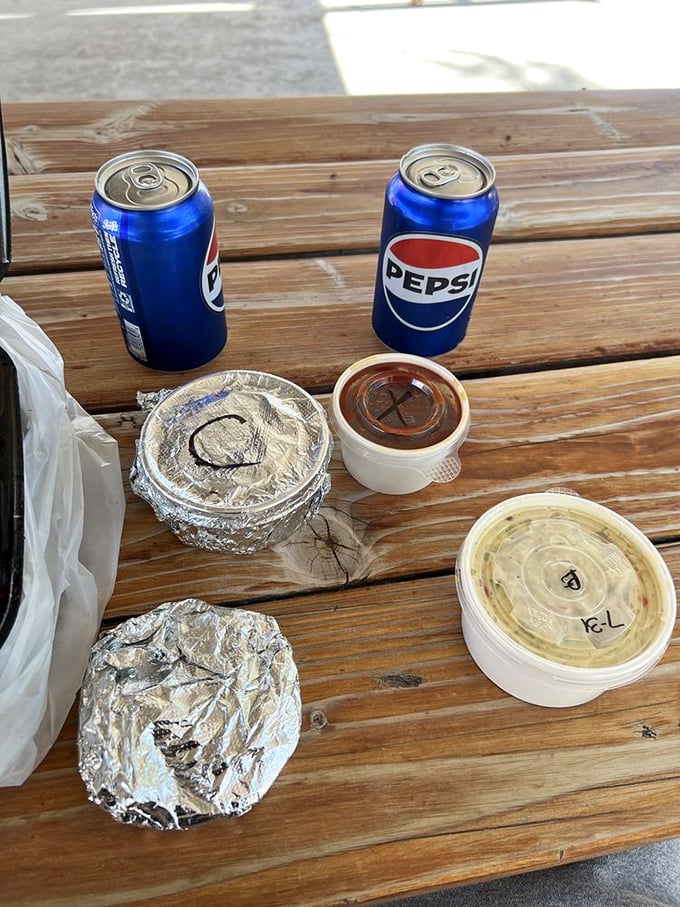 Simple pleasures: cold Pepsi in aluminum cans, sauce in plastic containers, and the anticipation of barbecue that makes waiting a pleasure.